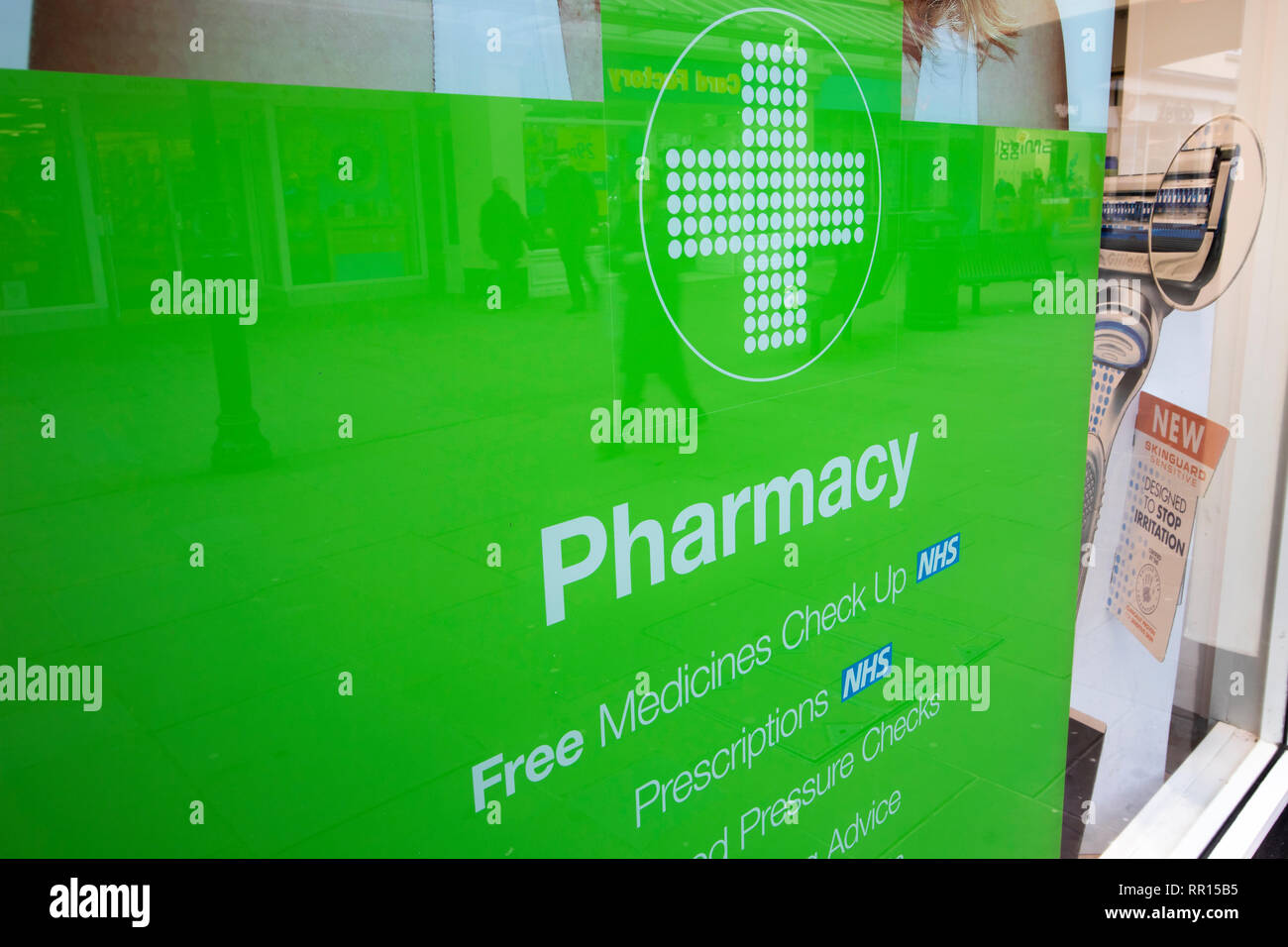National Health Service prescriptions sign in pharmacy shop window ...