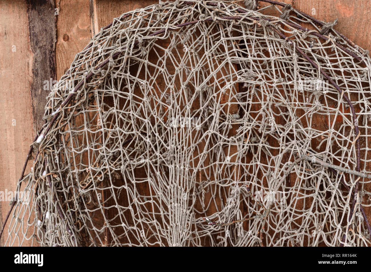 Old fishing nets hanging on wooden brown wall Stock Photo - Alamy