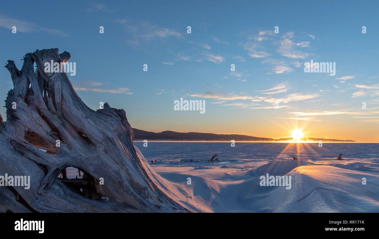 Sunrise over the Bay of Gaspé and the Forillon Peninsula on cold winter ...