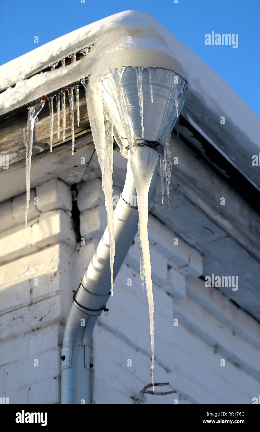 Beautiful big icicles hanging on the building take a close-up picture ...