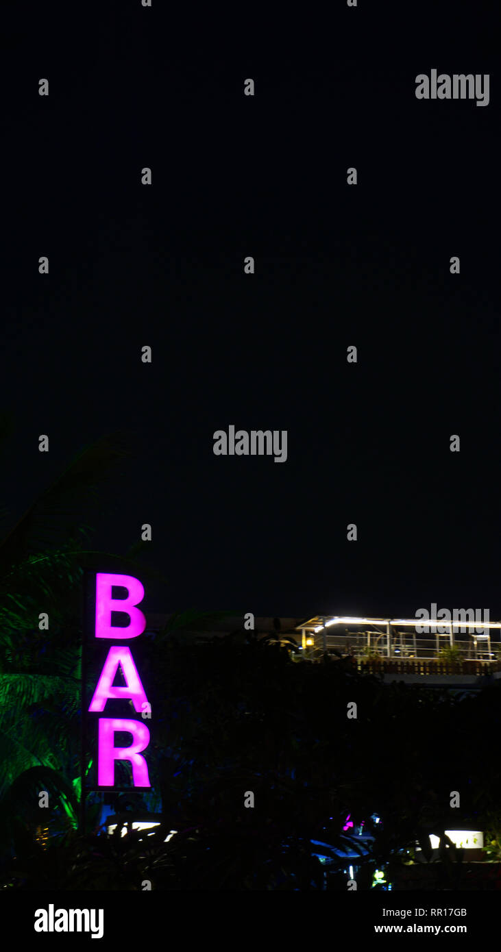 Flouresant neon pink Bar sign - vertical black background Stock Photo ...