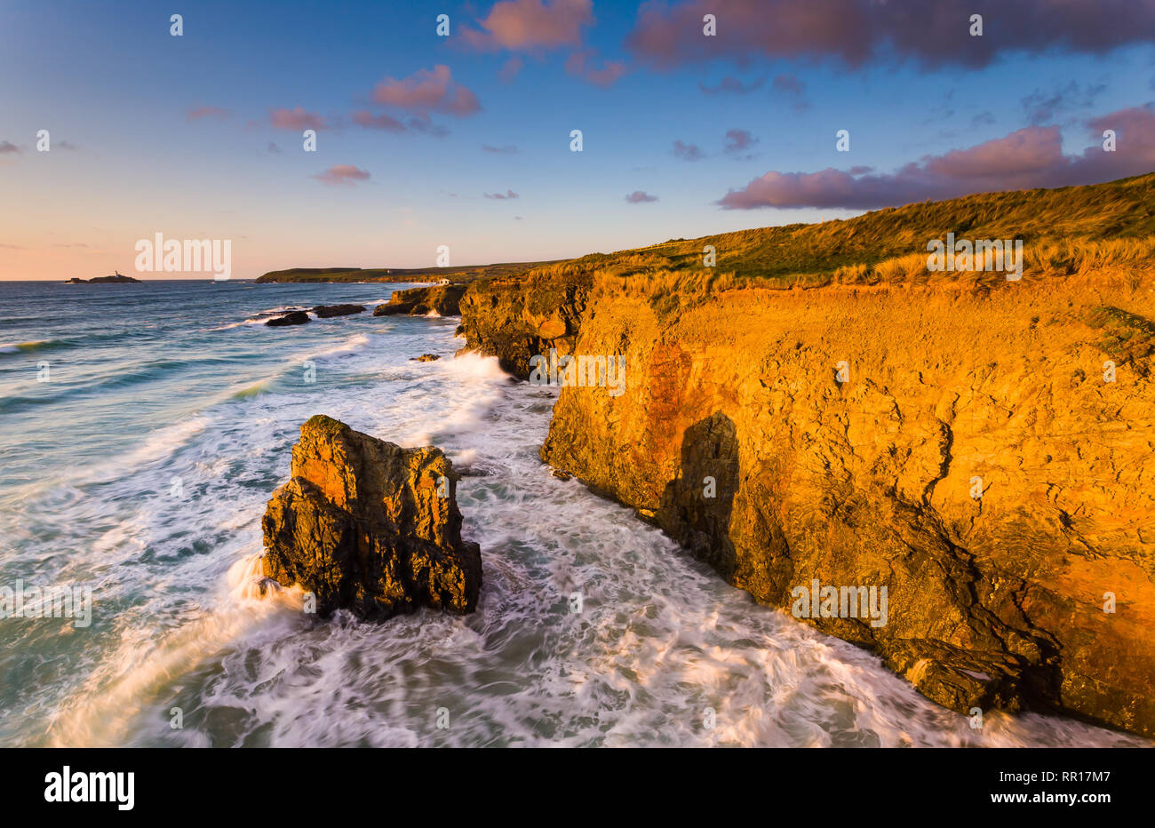 Dramatic sunset light illuminating the cliffs at Gwithian Cornwall ...