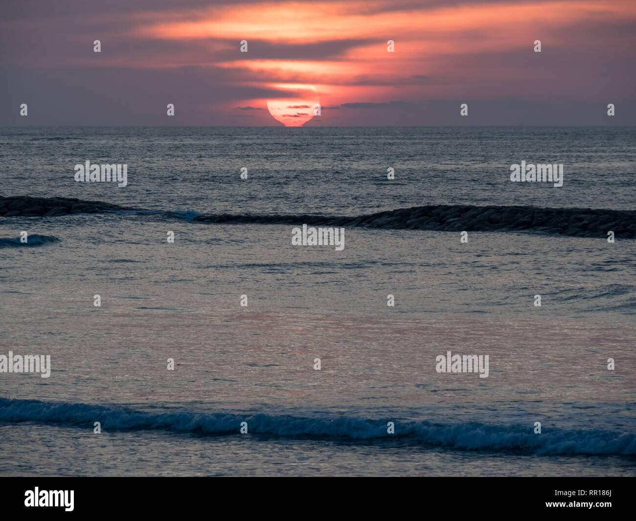 Sun kissing the ocean at sunset Kuta Bali Stock Photo - Alamy