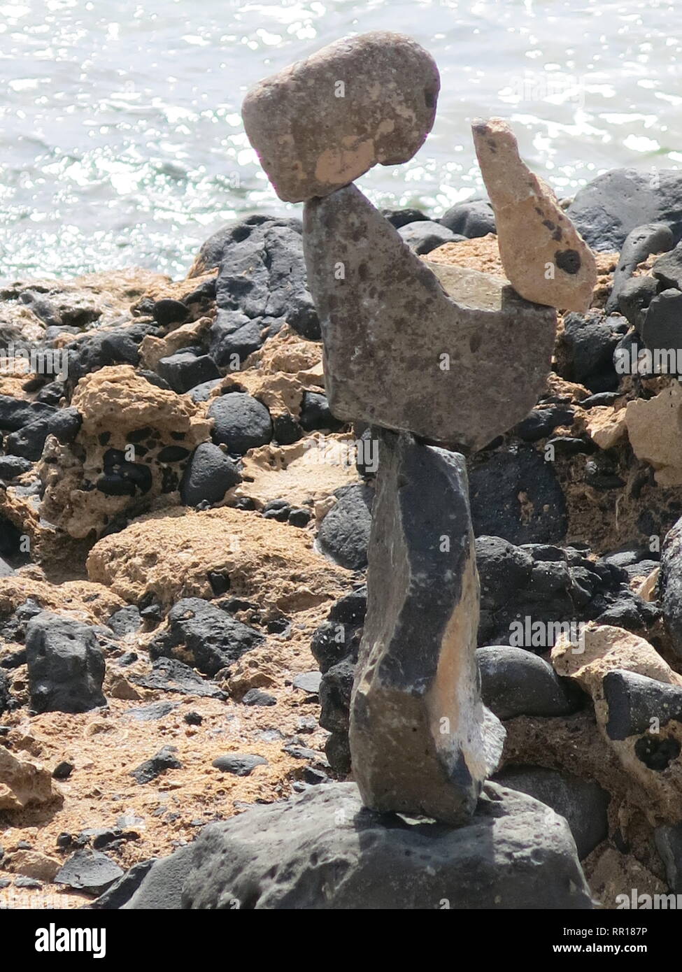 Child stacking rocks hi-res stock photography and images - Alamy