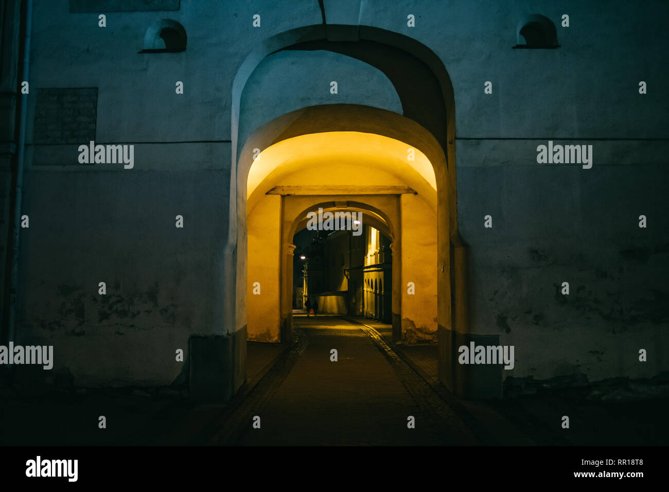 Illuminated entry arch with warm and cold light Stock Photo - Alamy