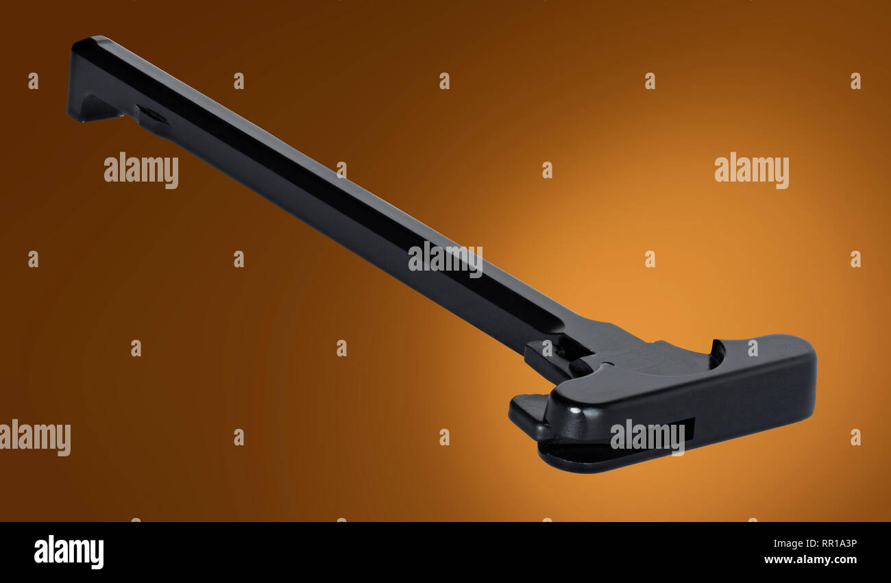 Handle used to reload an AR-15 on a beige background Stock Photo - Alamy