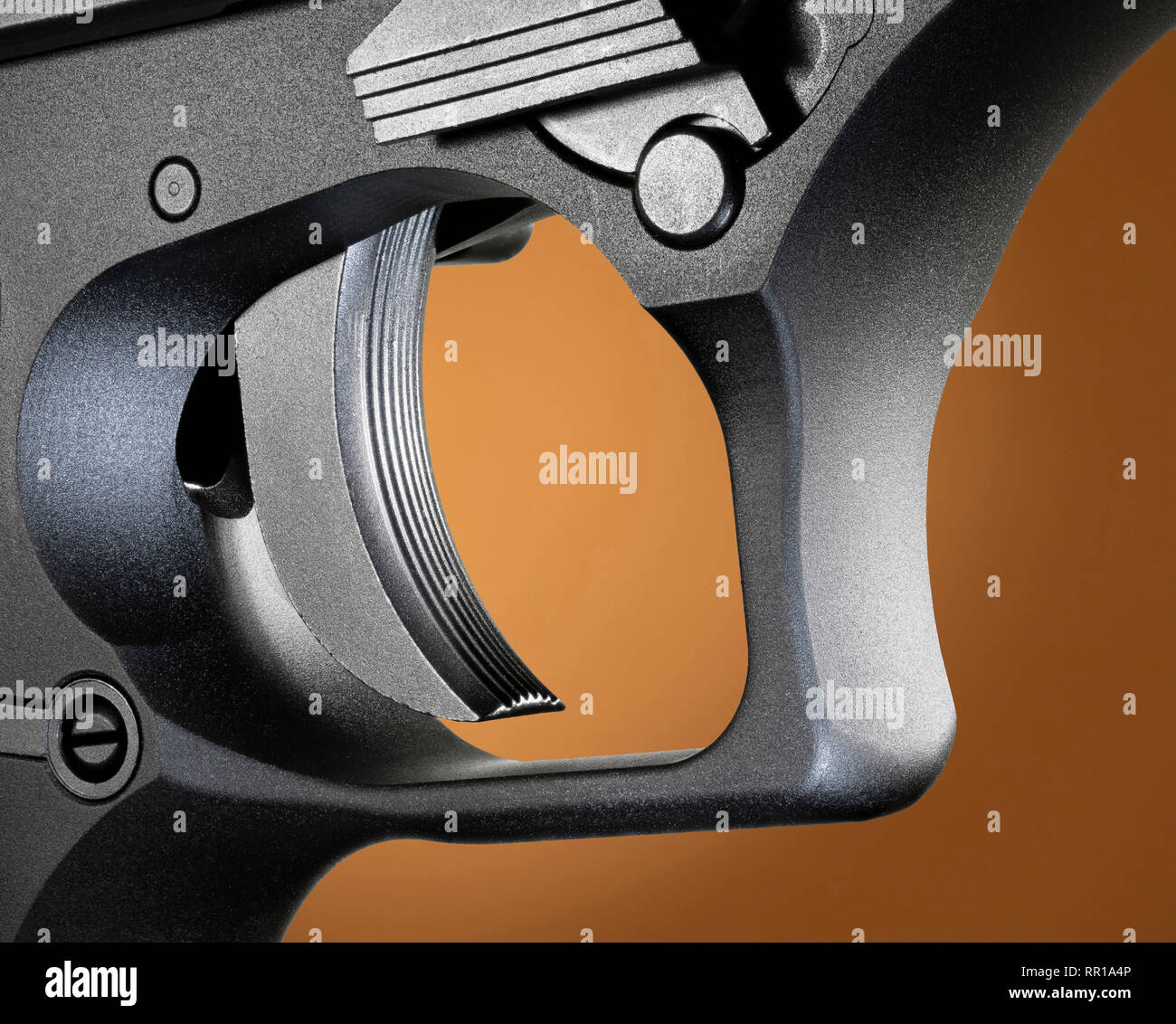 Trigger on a semi auto pistol on a beige background Stock Photo - Alamy