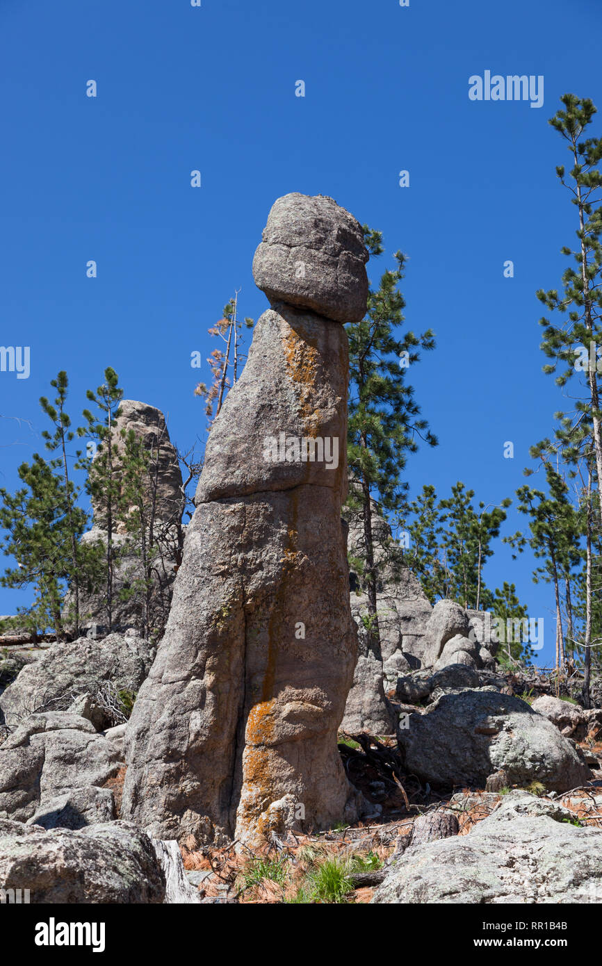 A large rock feature that has been eroded to resemble a head on top in ...