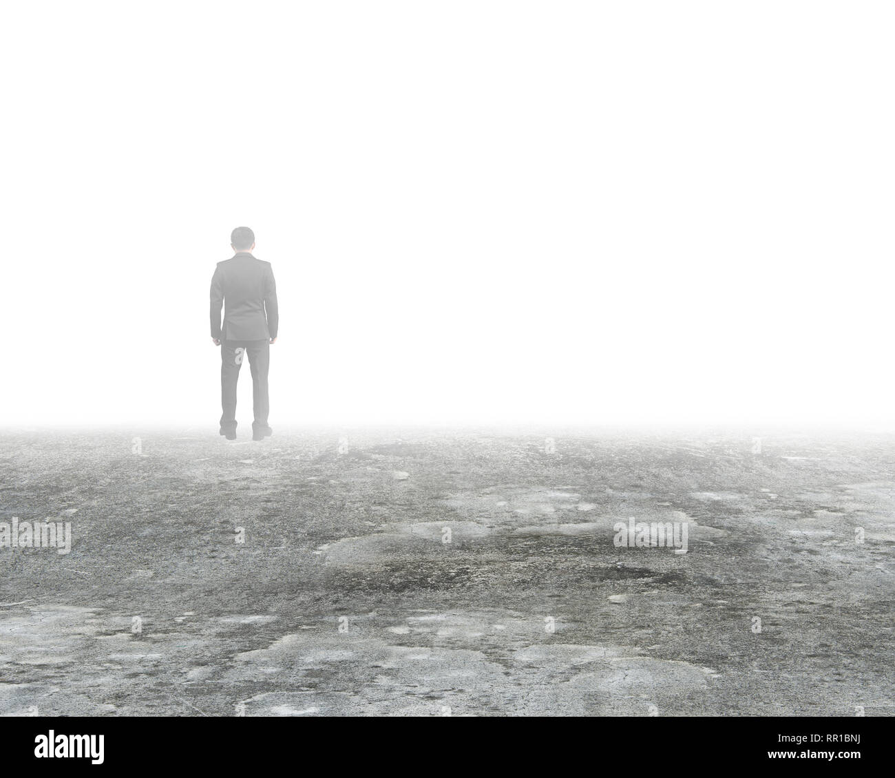 Man standing in mystery fog on dirty concrete floor Stock Photo - Alamy