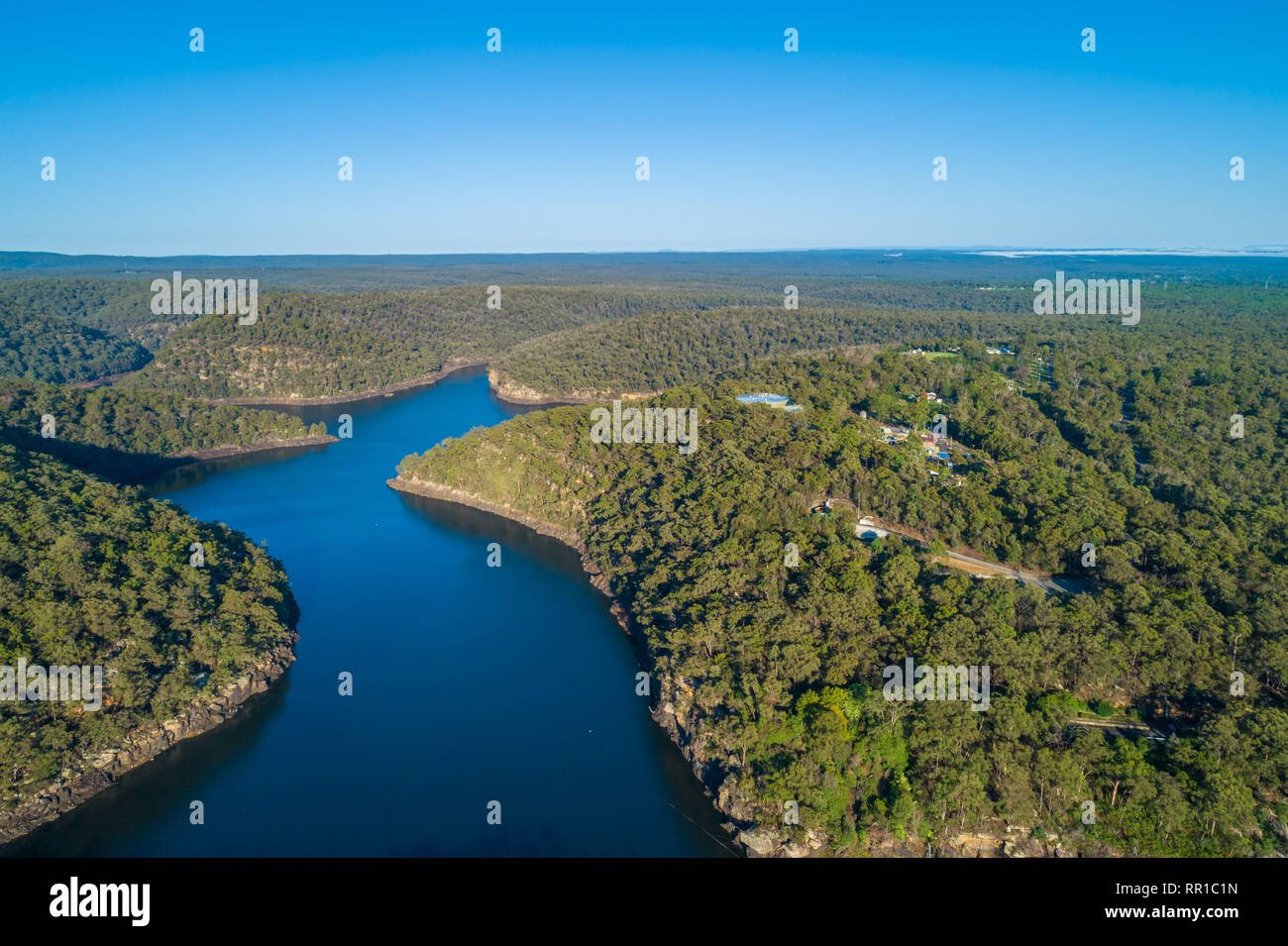 Aerial view of Nepean Lake and forested hills with clear blue sky ...