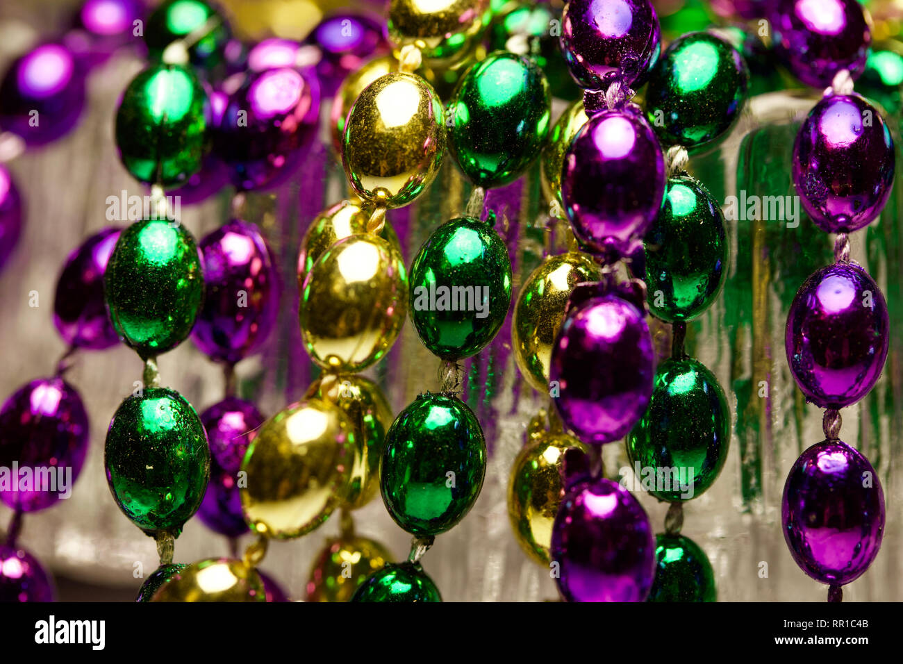 Macro art abstract of traditional three color Mardi Gras beads in a ...
