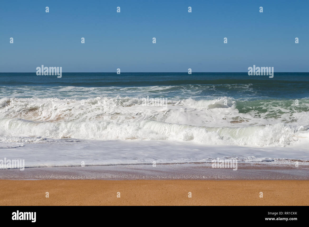 Clean dark yellow sand of the autumn beach. Deep blue color of the ...