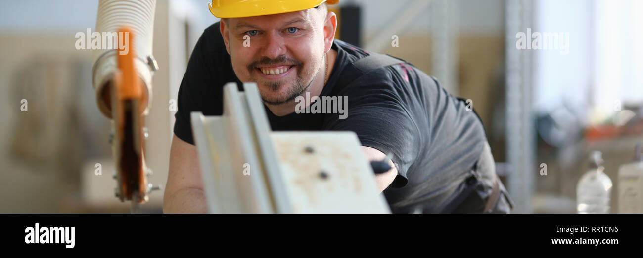 Worker using electric saw portrait Stock Photo - Alamy