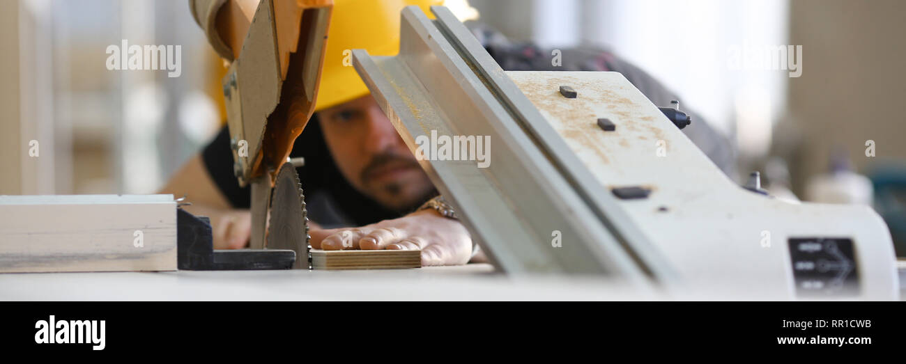 Worker using electric saw portrait Stock Photo - Alamy