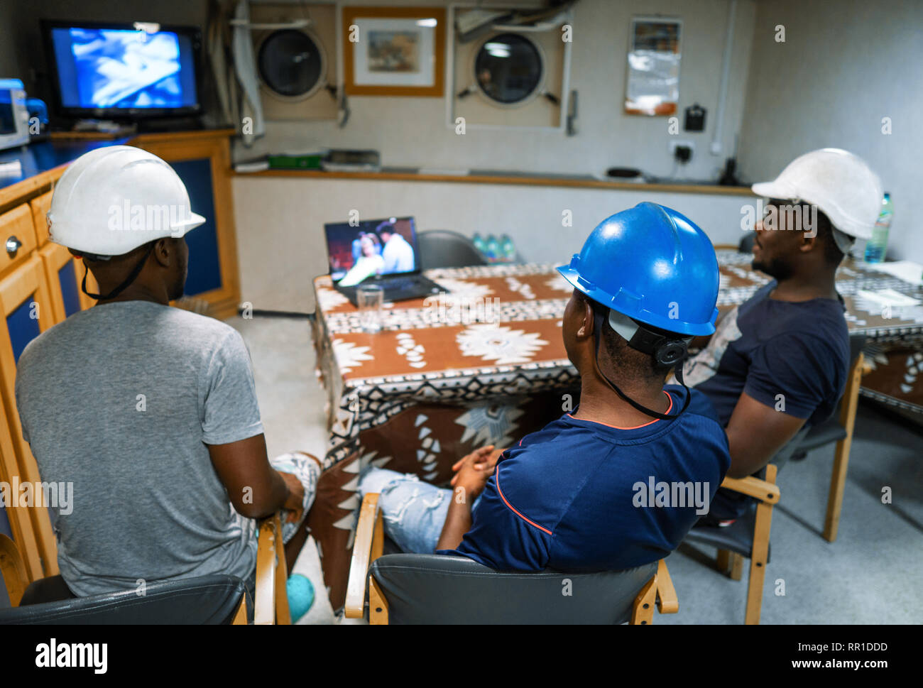 Seamen crew onboard a ship or vessel having fun watching movie Stock ...