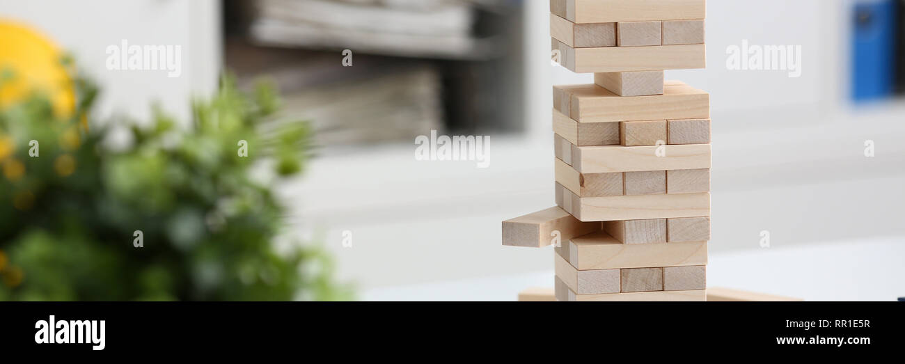 Businessman plays in a strategy of jenga hand Stock Photo - Alamy