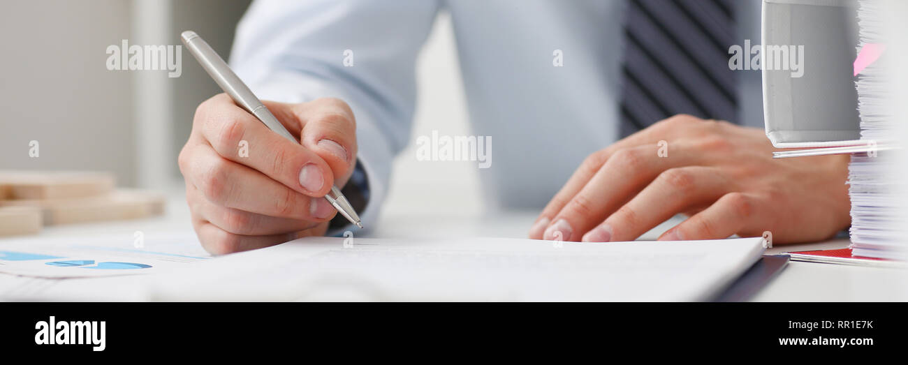 Male hand holding silver pen ready to Stock Photo - Alamy