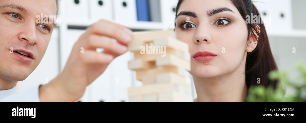 Businessman plays in a strategy of jenga hand Stock Photo - Alamy
