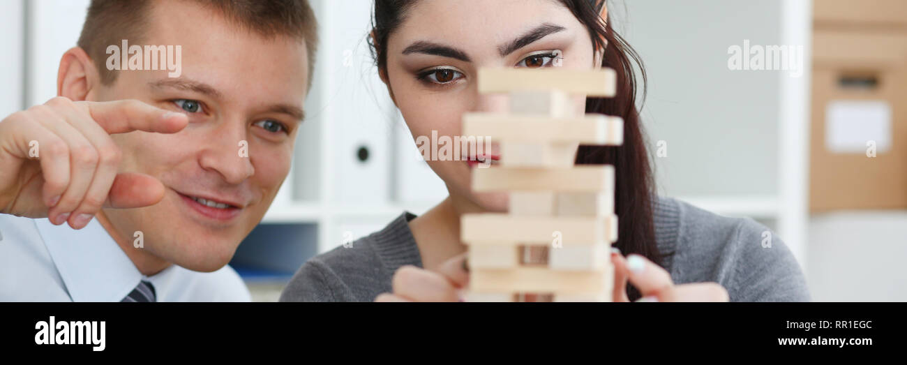 Businessman plays in a strategy of jenga hand Stock Photo - Alamy