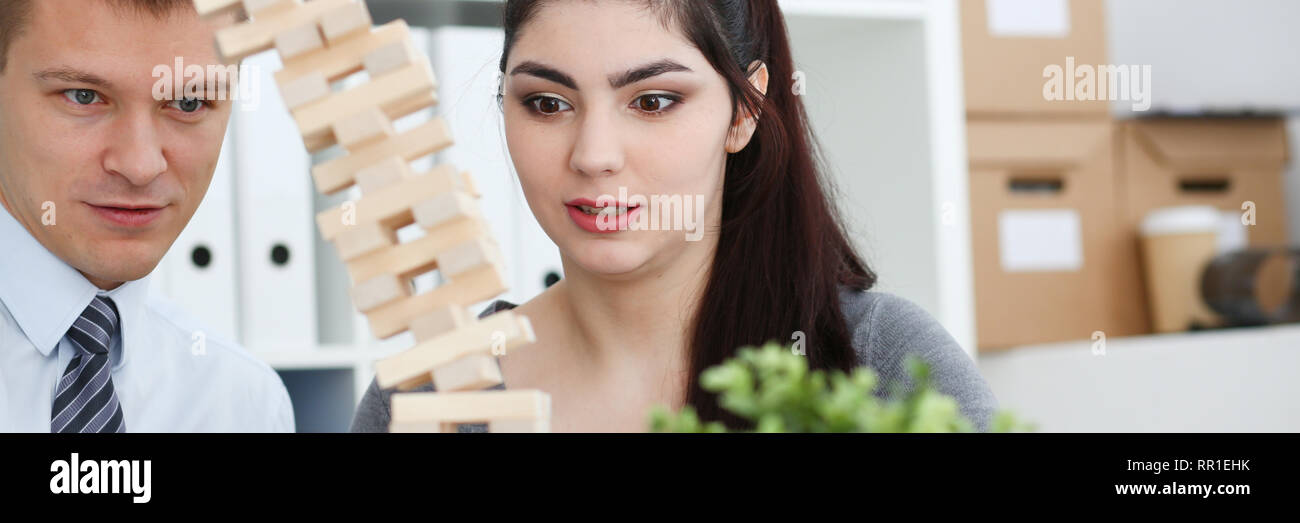 Businessman plays in a strategy of jenga hand Stock Photo - Alamy