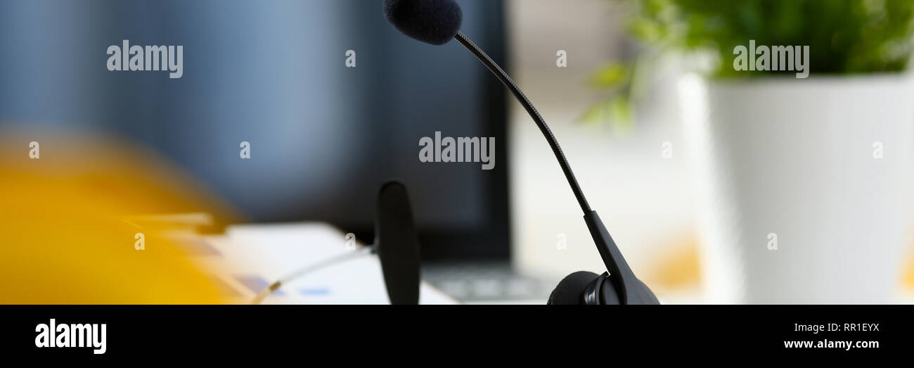 Empty remote office workplace with laptop and headset Stock Photo - Alamy