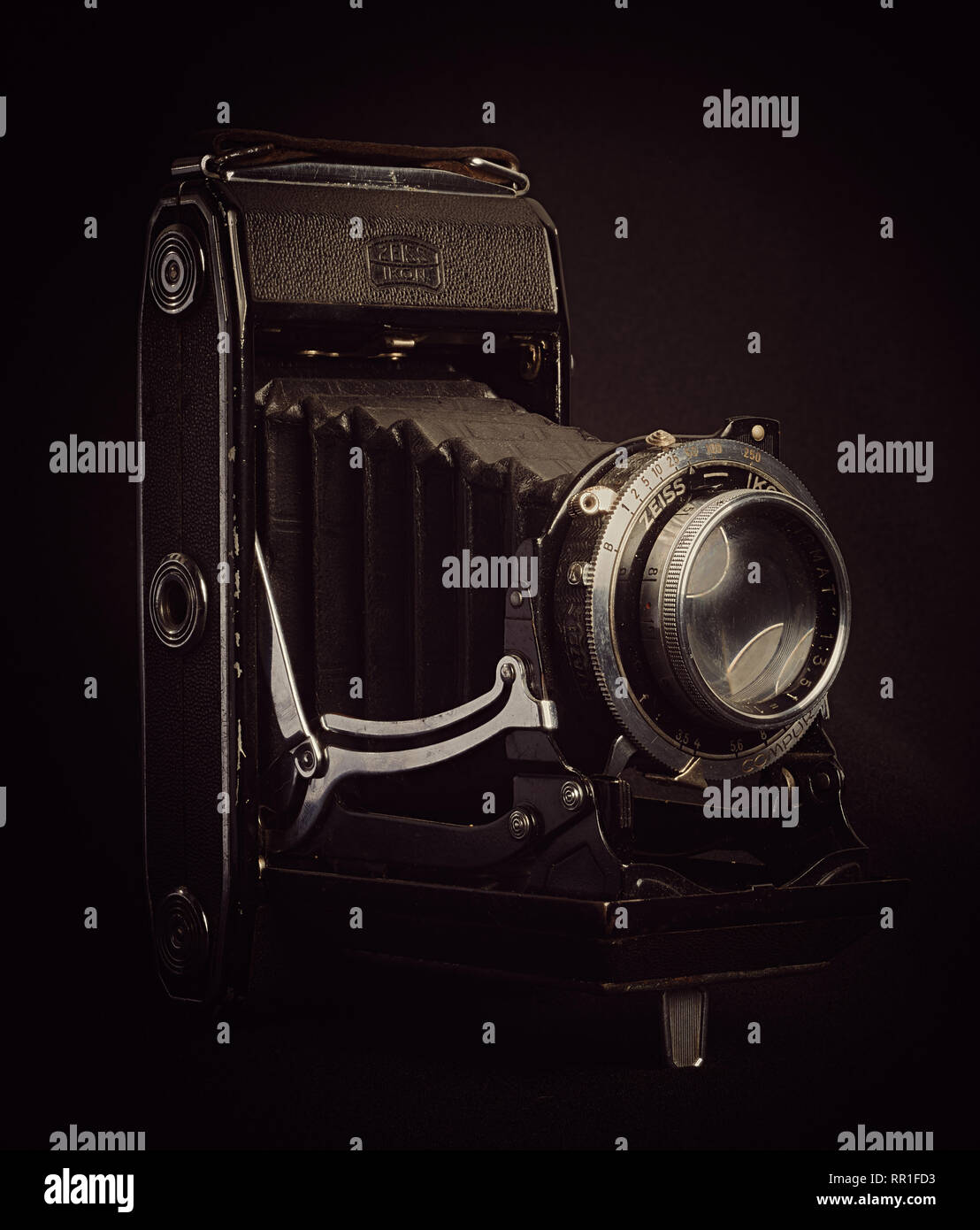 Vertical aspect right side view of a vintage bellows film camera ...