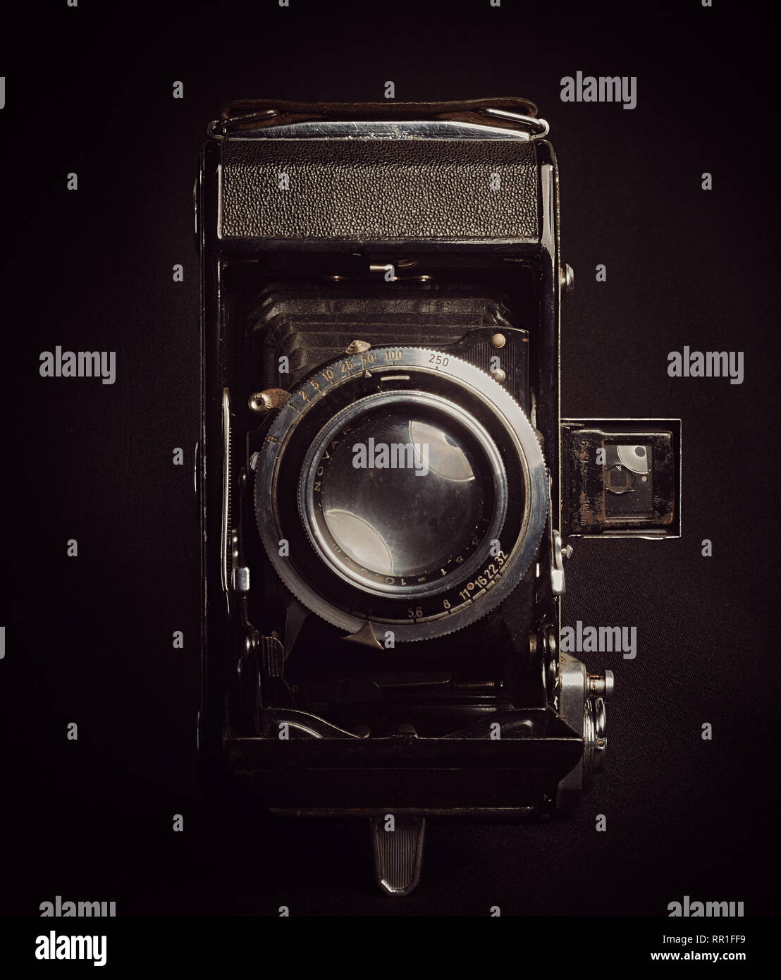 Vertical aspect front view of an unbranded vintage bellows film camera ...