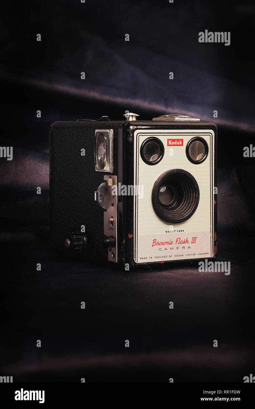 Vertical aspect right side view of a vintage box camera against a black ...