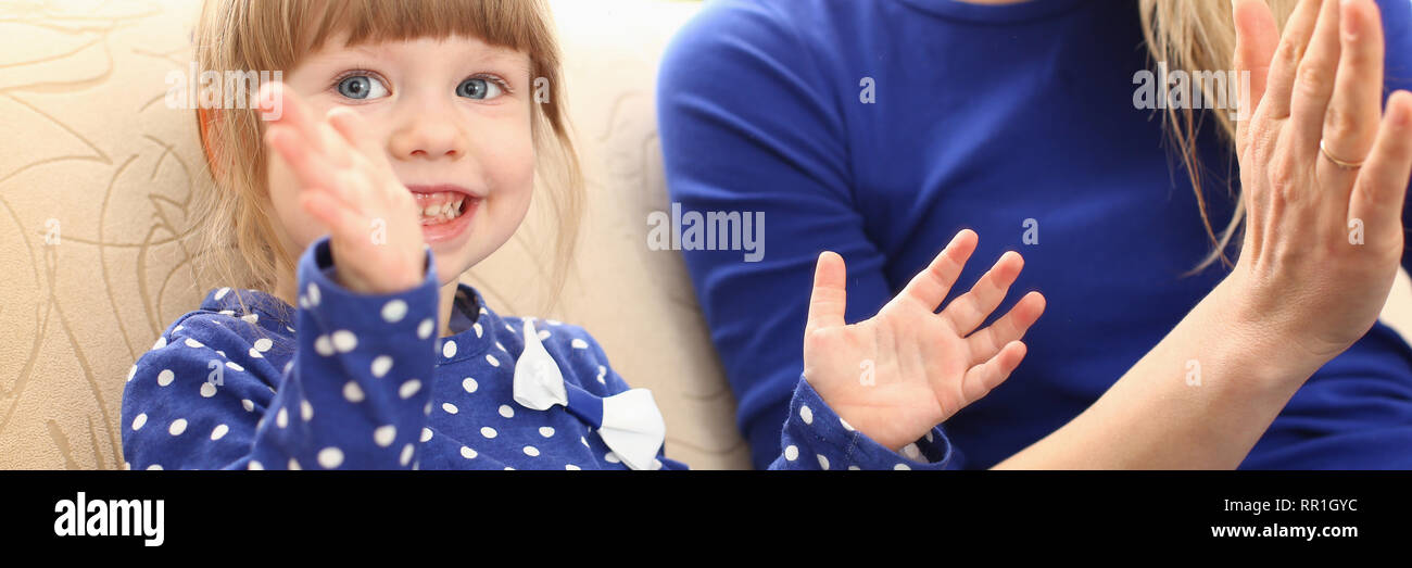 Cute little girl play with mom pat-a-cake Stock Photo - Alamy