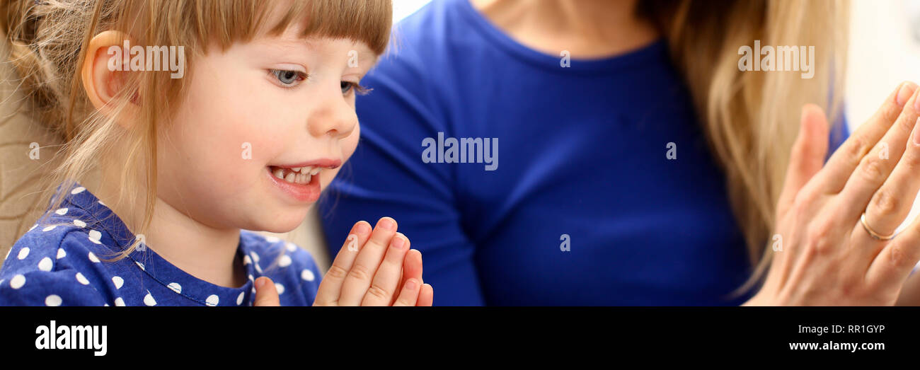 Cute little girl play with mom pat-a-cake Stock Photo - Alamy