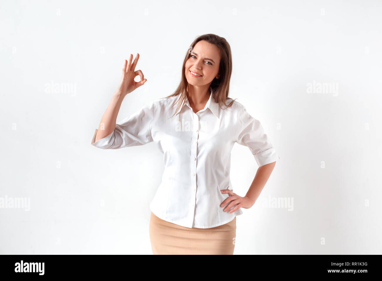 Everything is good. Woman standing isolated on white showing ok sign ...