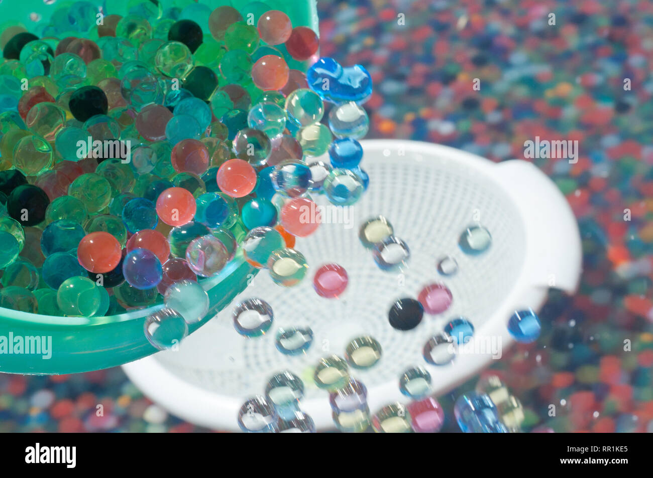 Falling multicolored water beads Stock Photo - Alamy