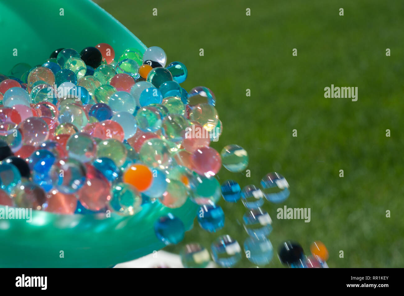 Falling multicolored water beads Stock Photo - Alamy
