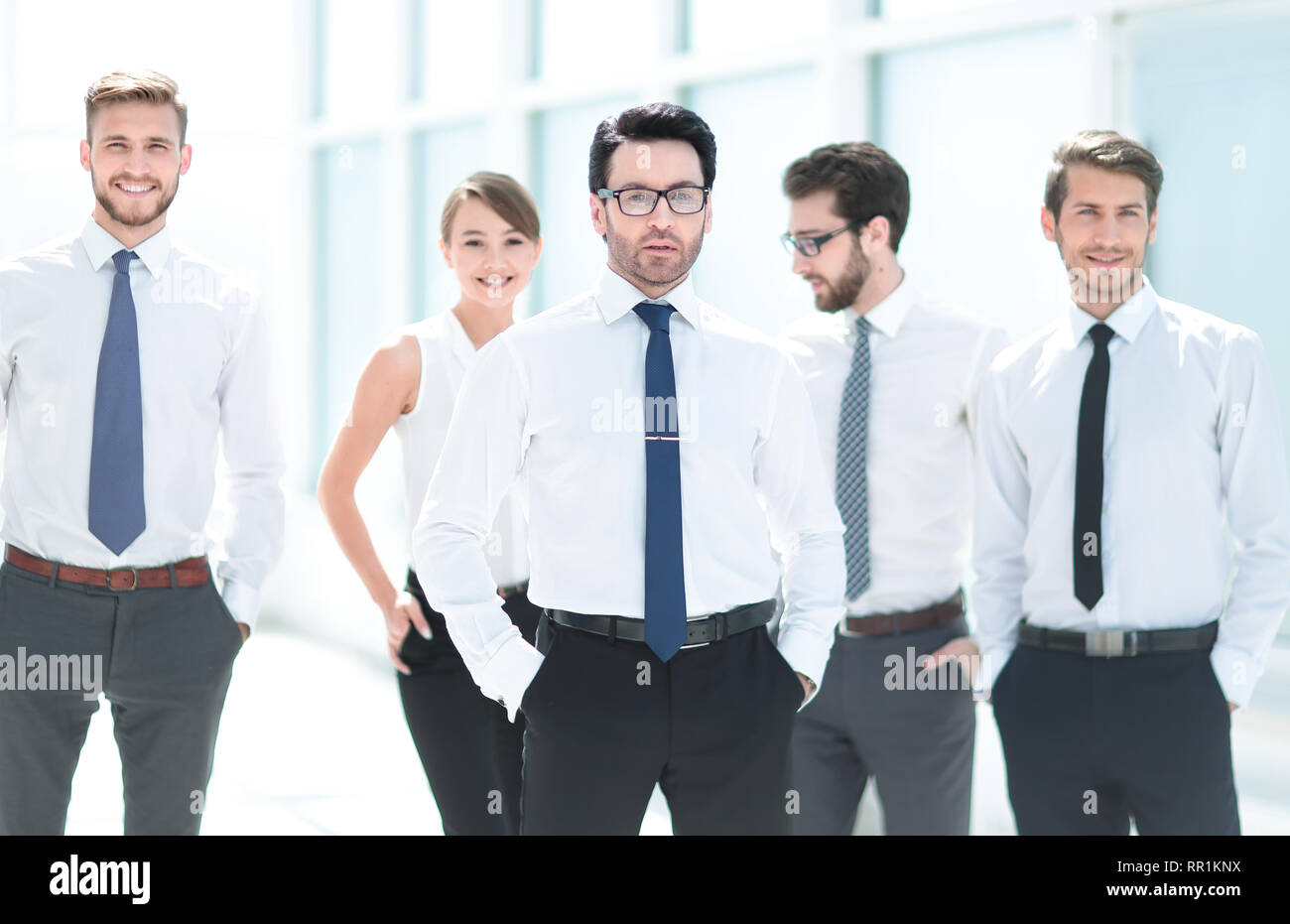employees standing in a bright office Stock Photo - Alamy