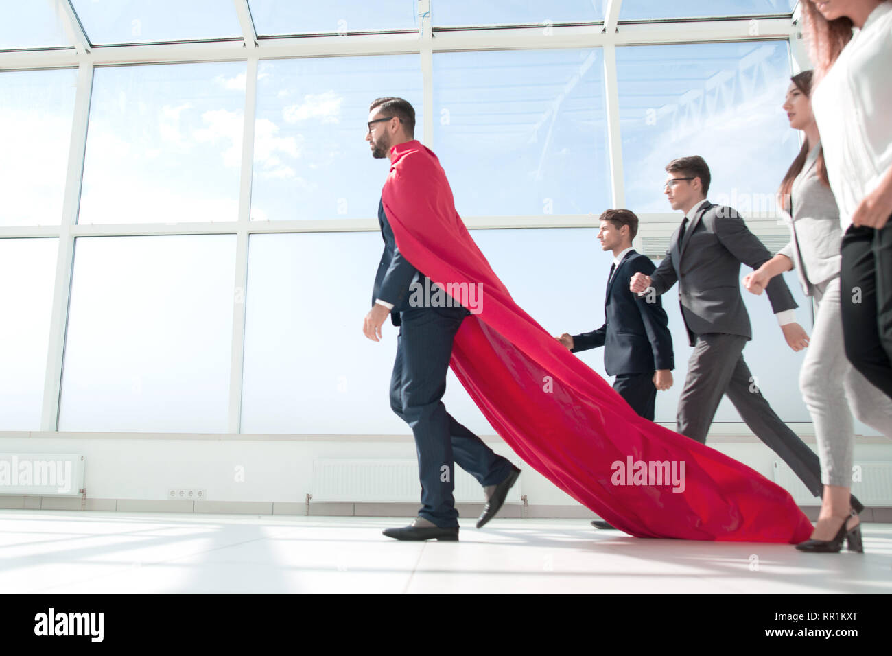 side view.businessman superhero goes ahead of his business team Stock ...