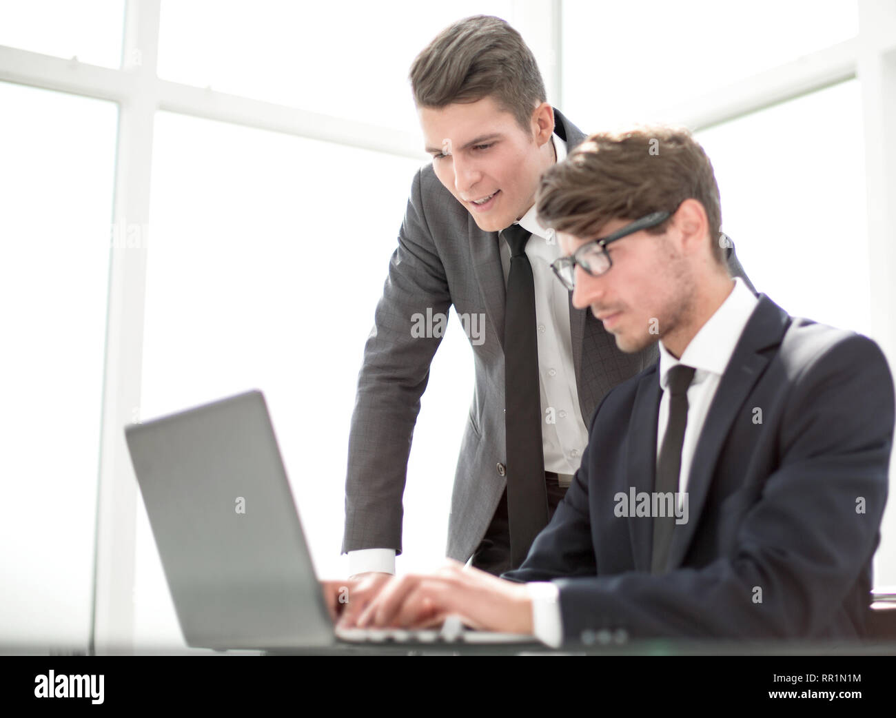 employees use a laptop to check the information they need Stock Photo ...