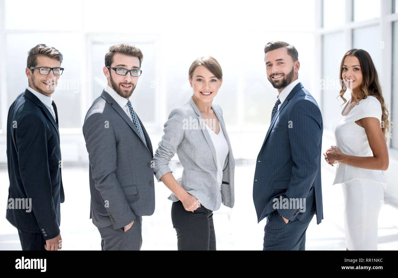 rear view.business team smiling and looking at the camera Stock Photo ...