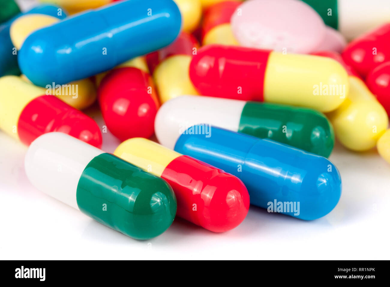 colorful pills isolated on white background Stock Photo - Alamy