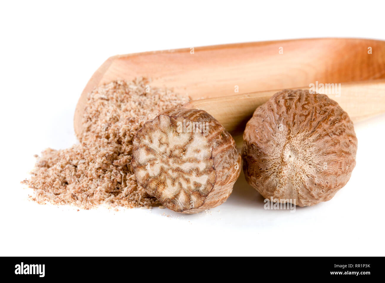 two nutmeg and powder isolated on white background Stock Photo - Alamy