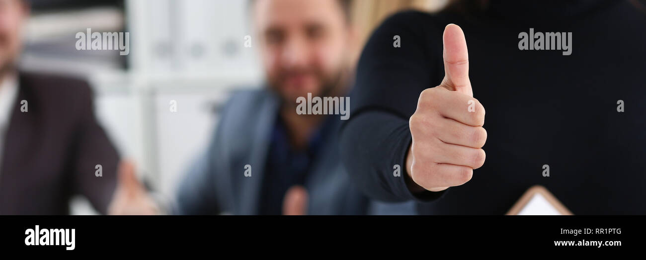 group of young businessmen are happy make good deal show big finger ...