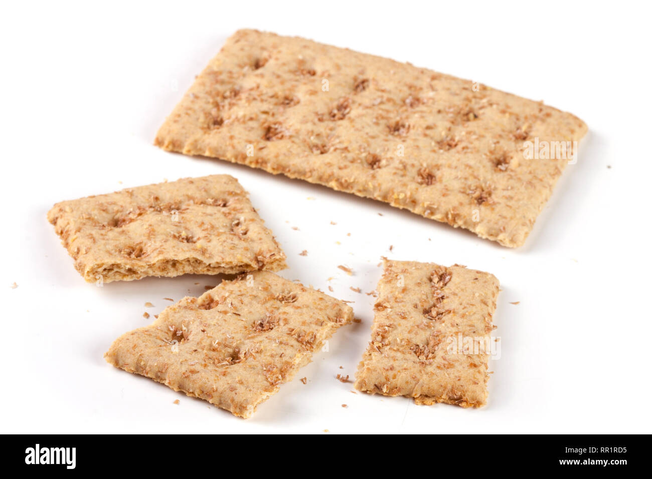 one whole and the broken grain crispbreads isolated on white background ...