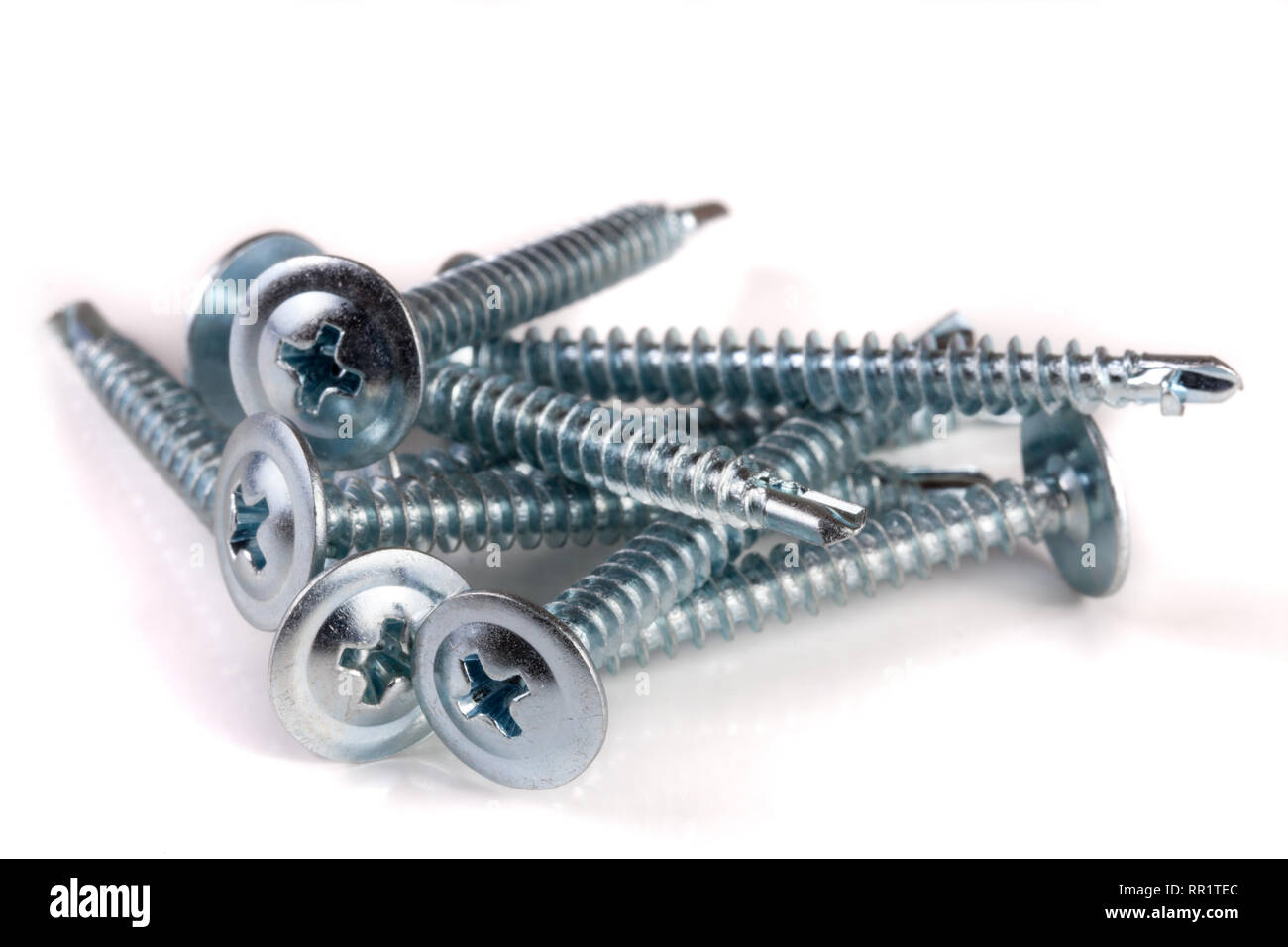 pile of metal screws isolated on white background Stock Photo - Alamy