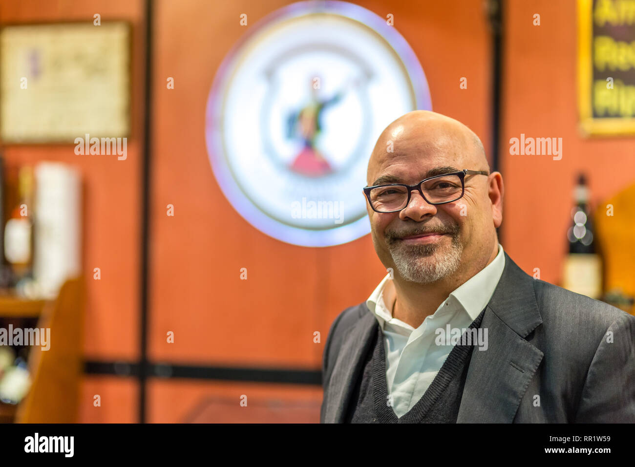 BOLOGNA, ITALY - FEBRUARY 18, 2019: booth presenter waiting for ...