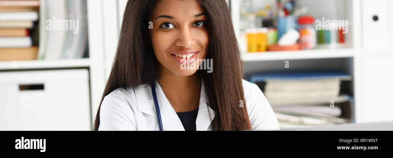 Beautiful smiling female doctor sit at workplace Stock Photo - Alamy