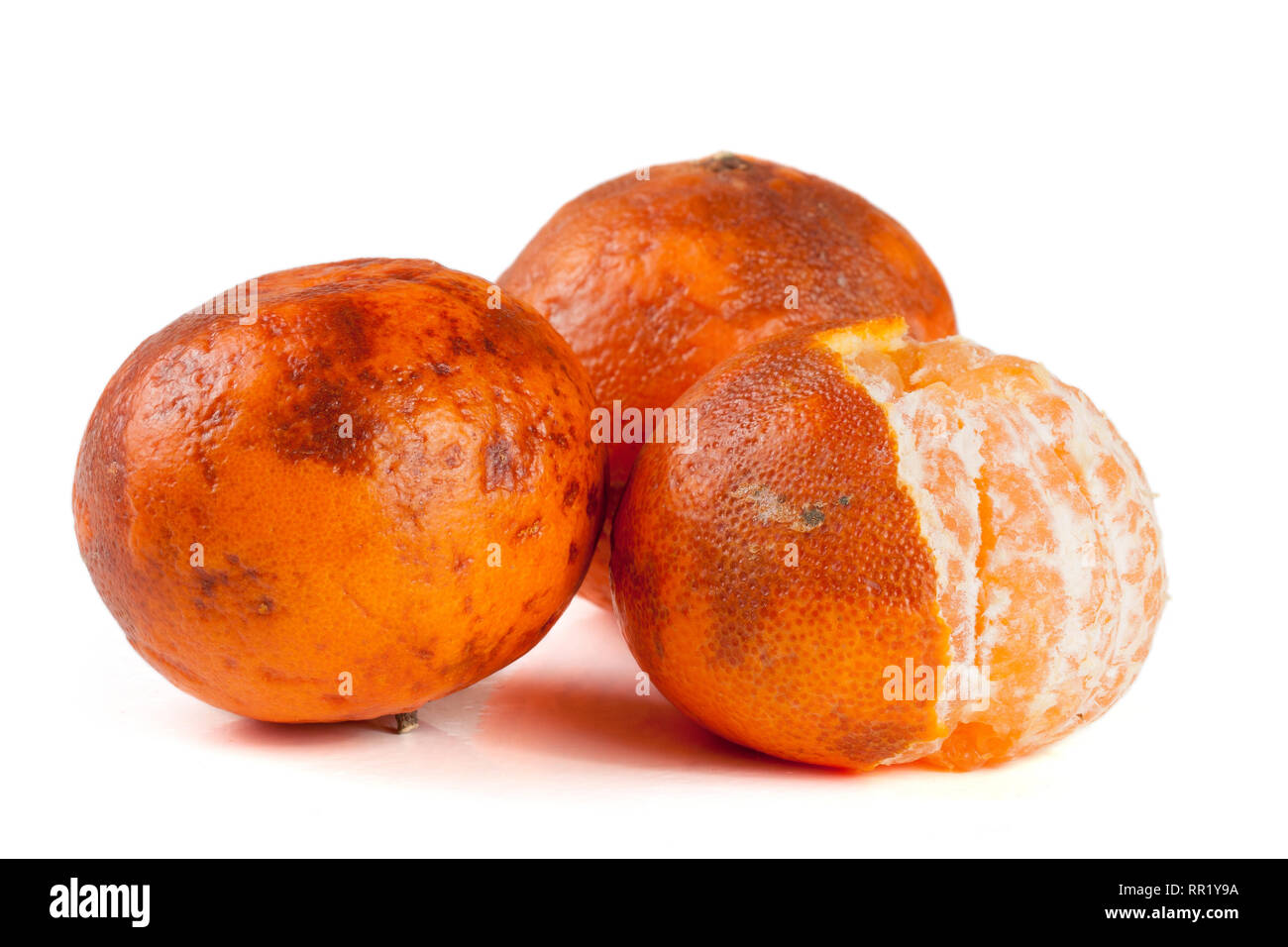 three damaged tangerine isolated on white background Stock Photo - Alamy