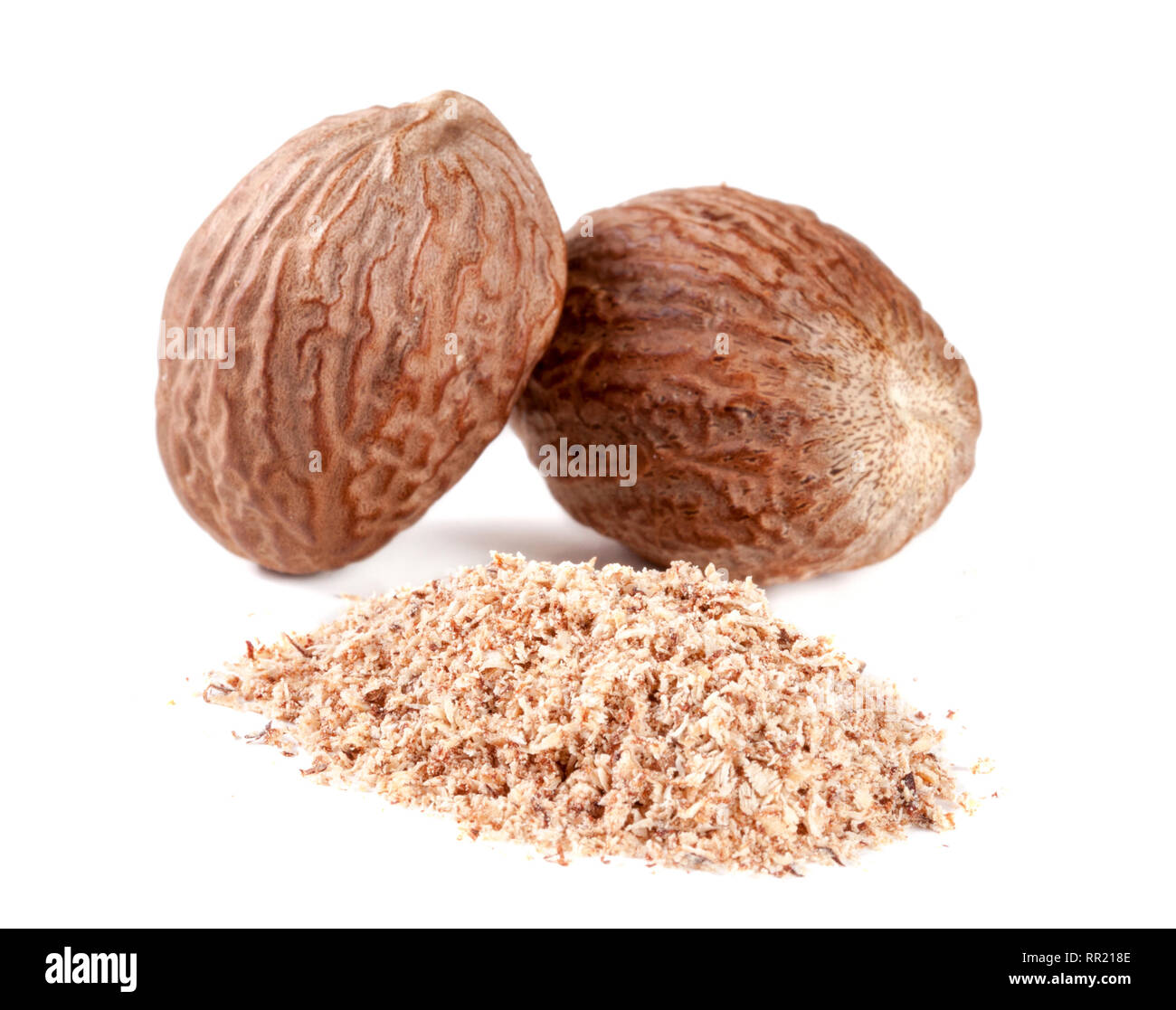 two nutmeg and powder isolated on white background Stock Photo - Alamy