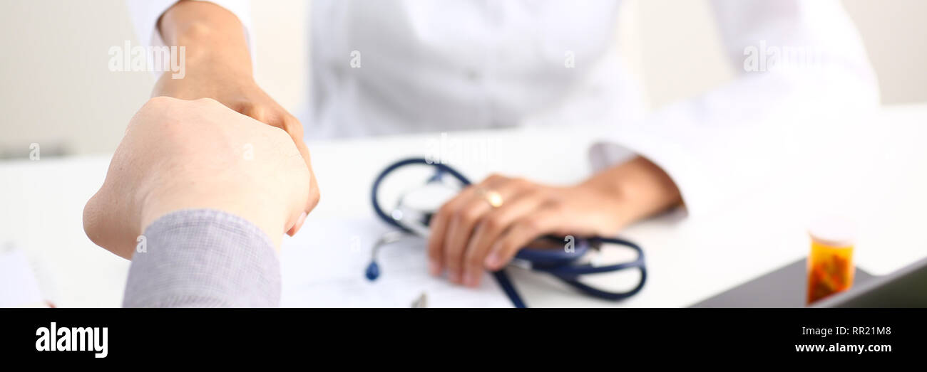 Doctor shake hand as hello with patient Stock Photo - Alamy