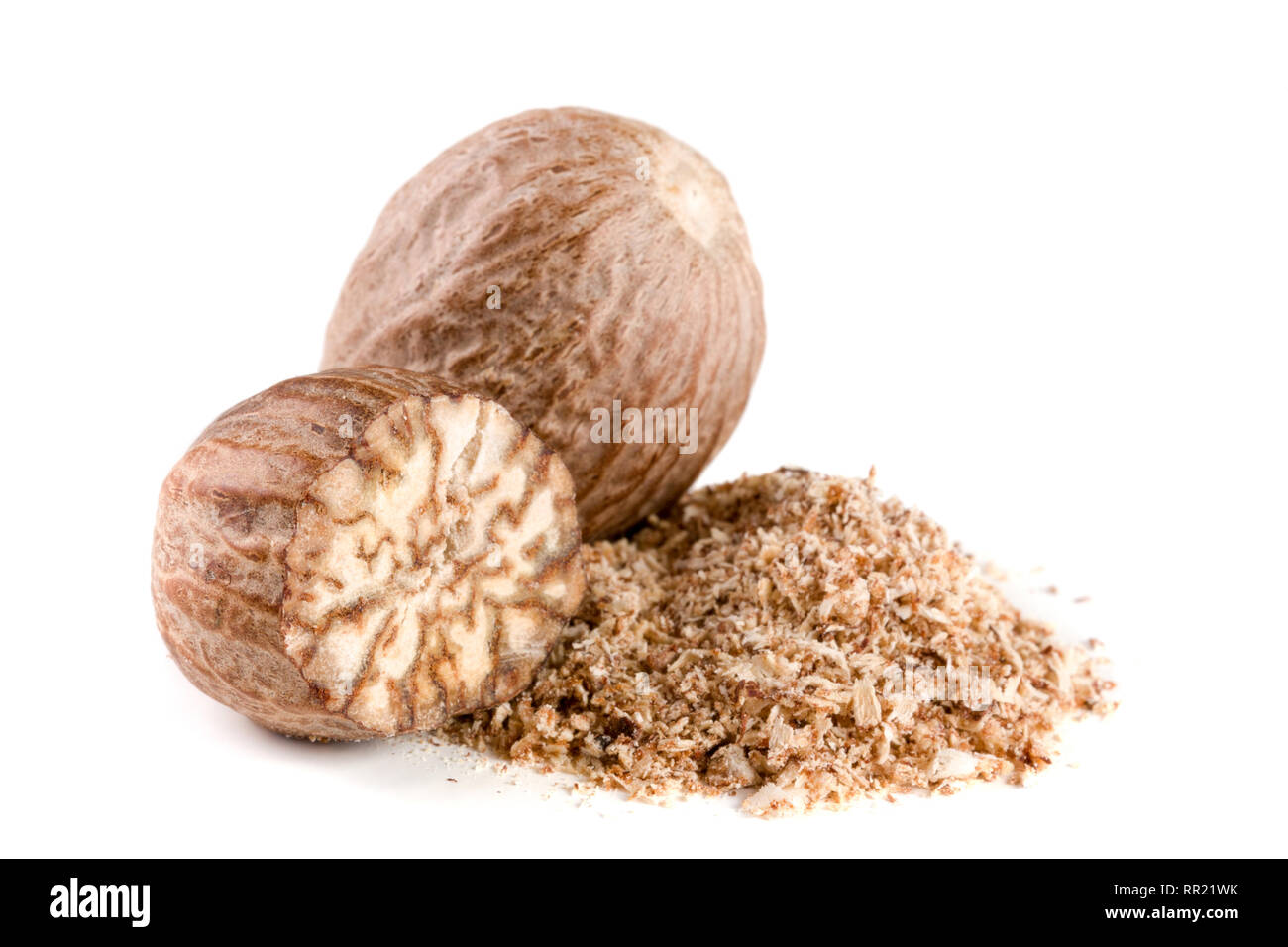 two nutmeg and powder isolated on white background Stock Photo - Alamy
