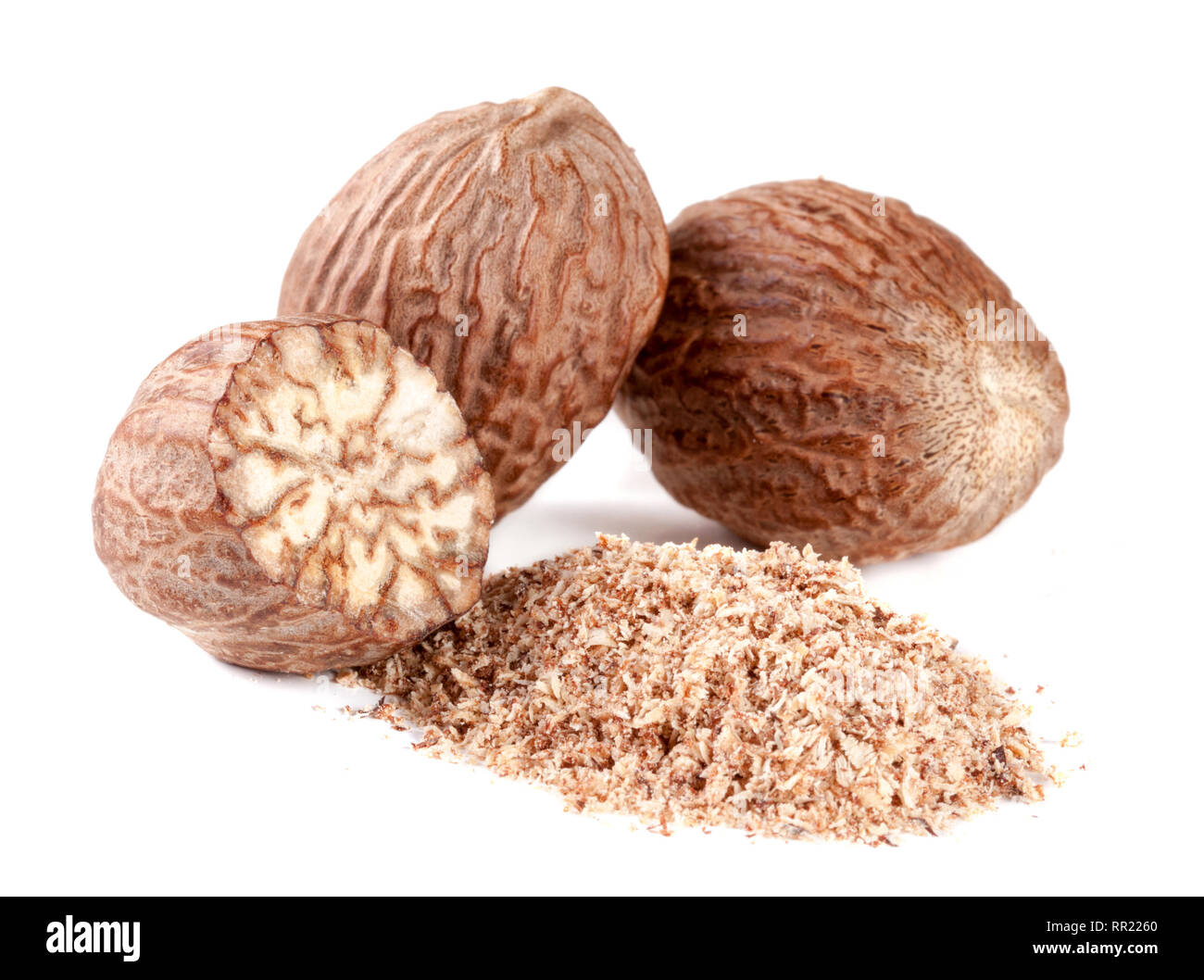 Three nutmeg and powder isolated on white background Stock Photo - Alamy