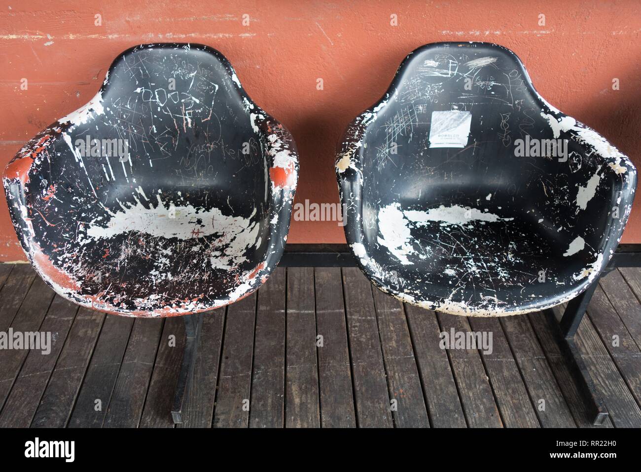 Scuffed up and scratched fiberglass chairs Stock Photo - Alamy